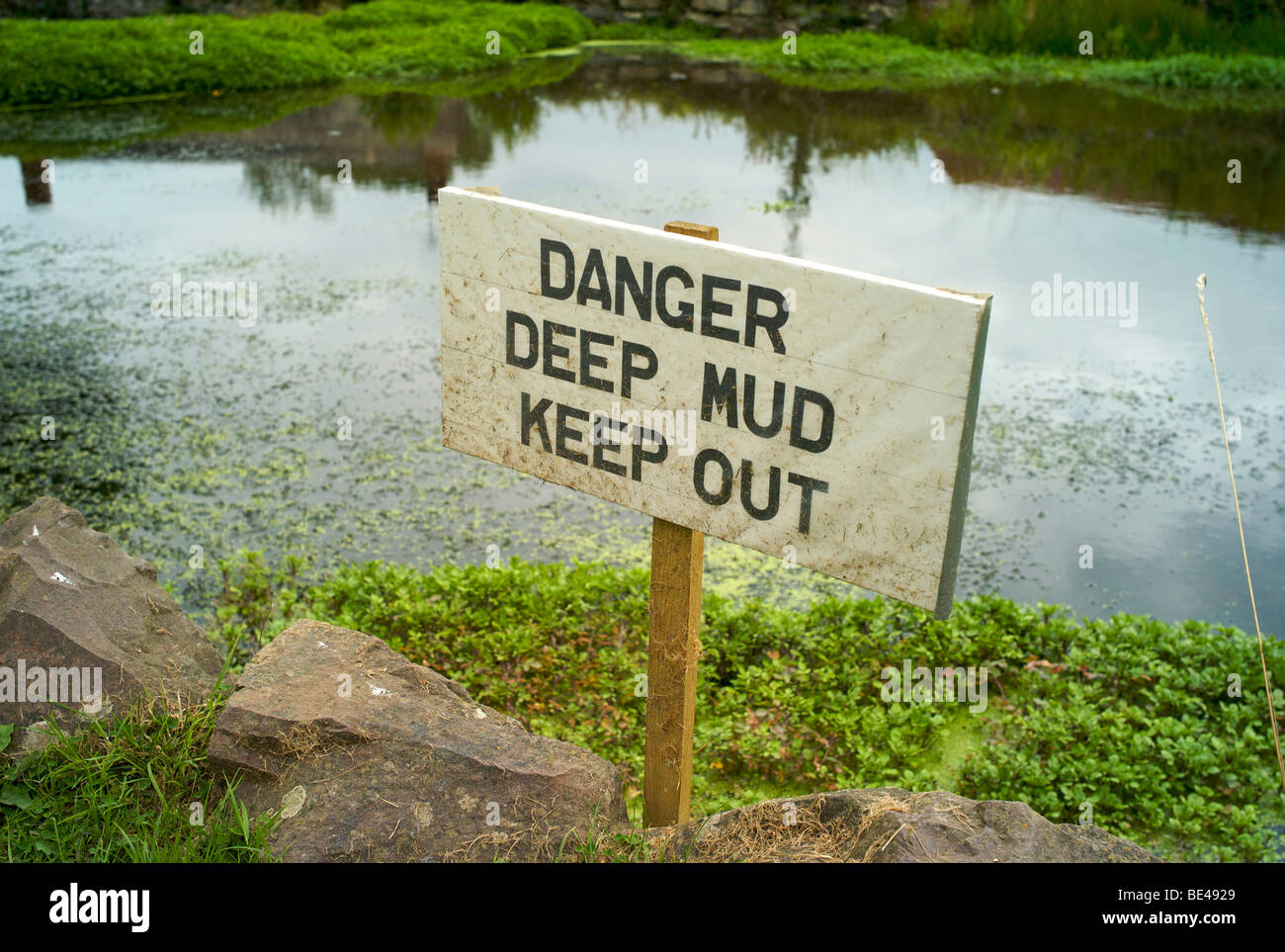 Danger warning sign next to a village pond Stock Photo - Alamy