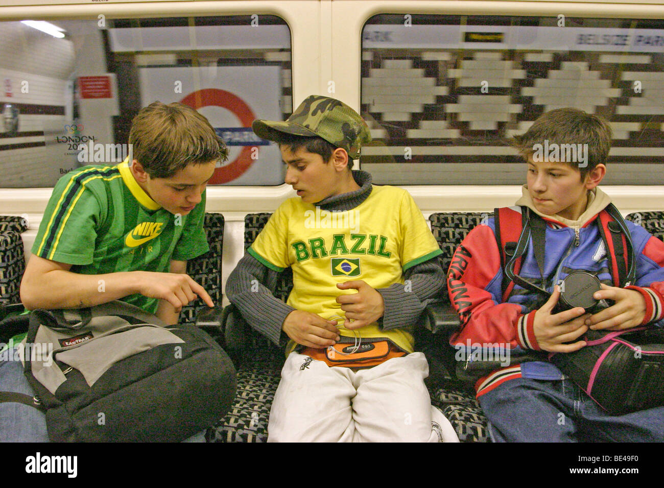 three young boys traveling by Underground Train in London Stock Photo ...