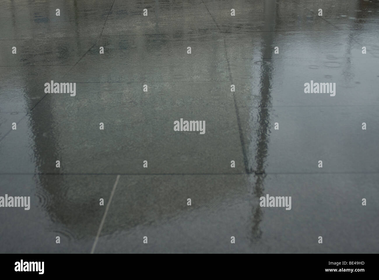 inverted reflection of office buildings in a flooded pavement Stock ...