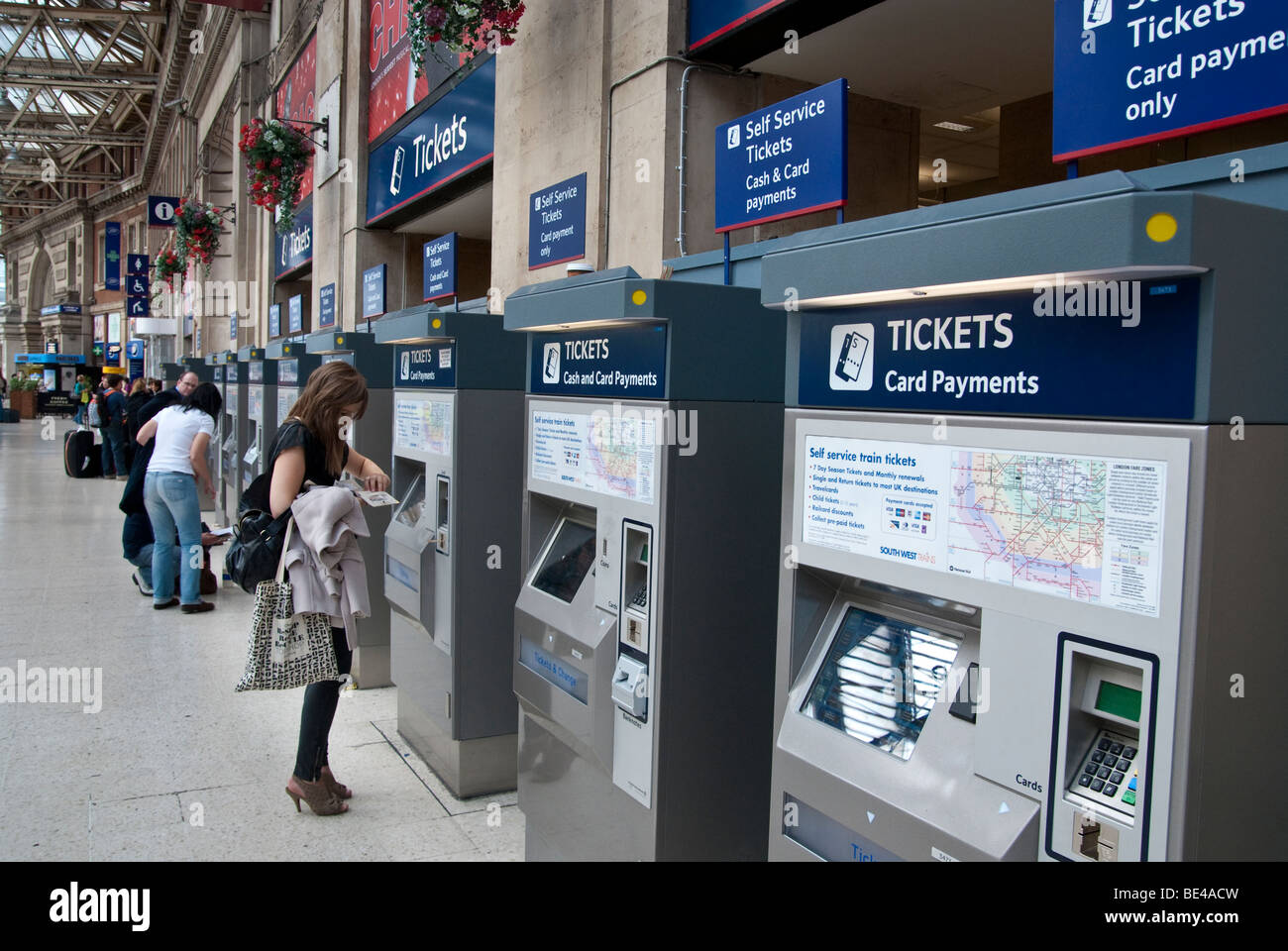 Passengers buying tickets at automatic ticket machin at Waterloo ...