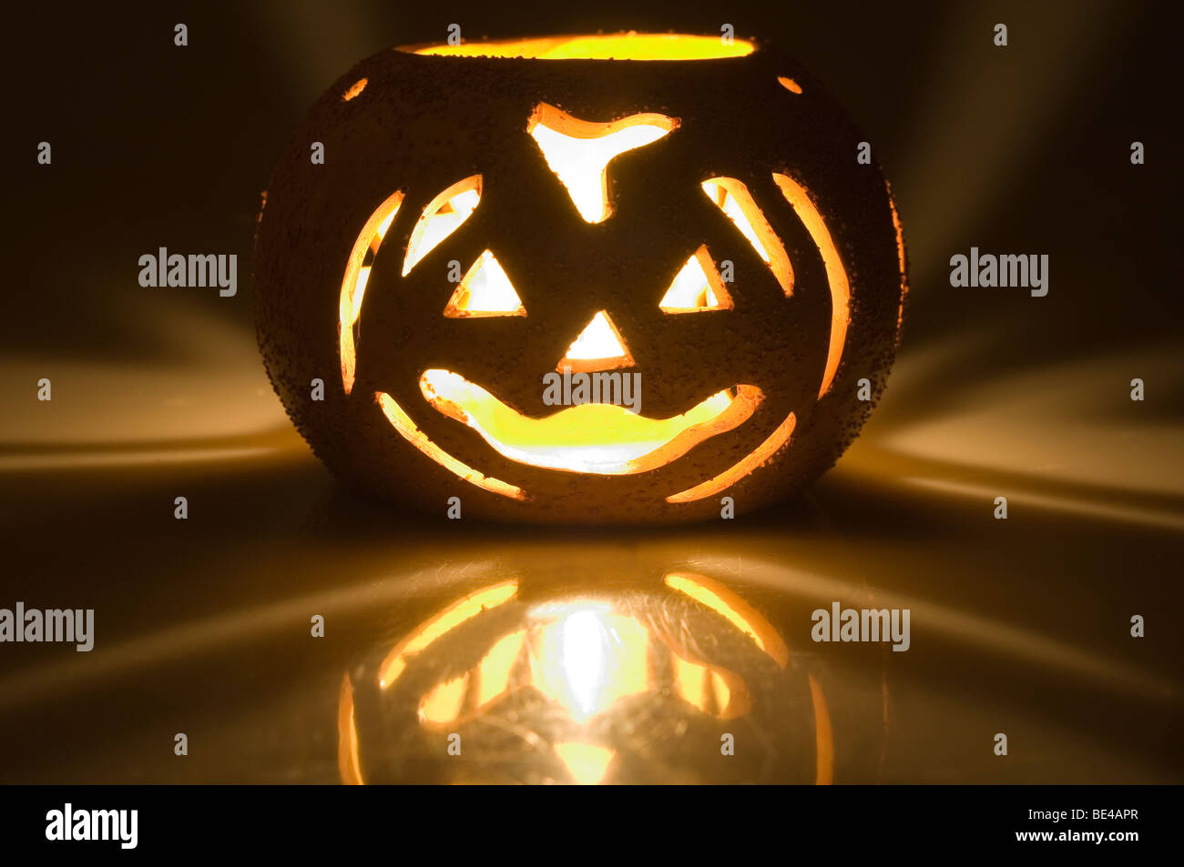 Halloween pumpkin lit from inside casting light and silhouettes all ...