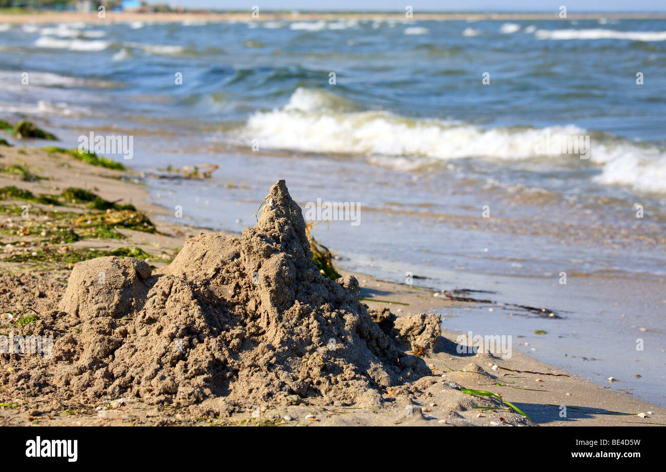 Sandy castle on summer sea coastline Stock Photo - Alamy