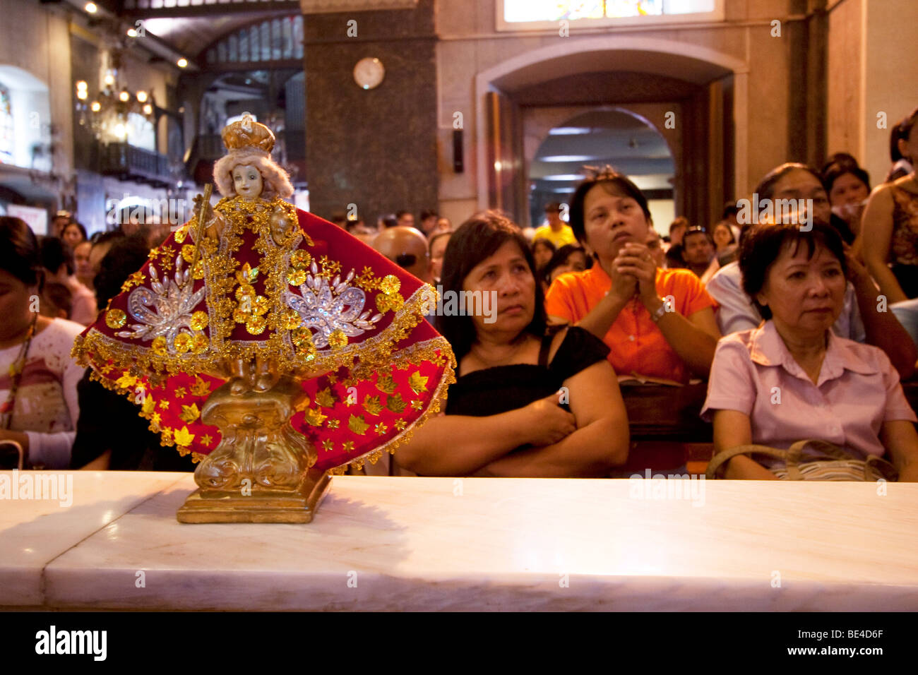 Religious devotees inside the church of Santo Nino in Cebu City Stock ...