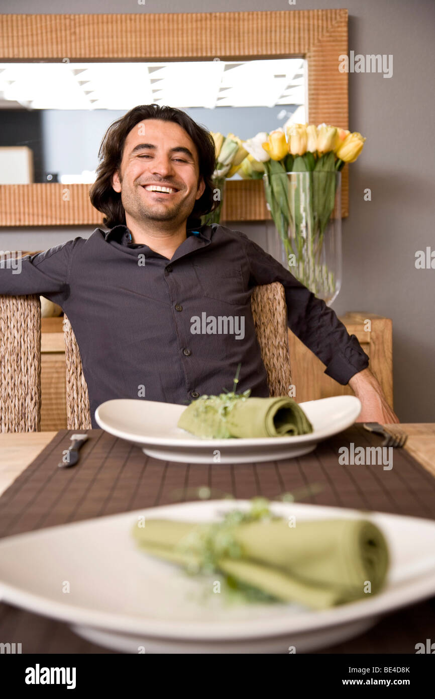 Man sitting at table hi-res stock photography and images - Alamy
