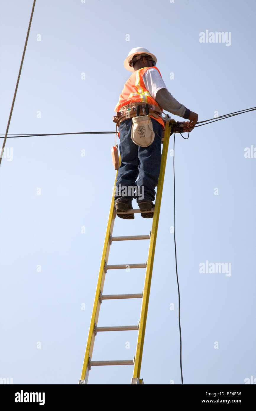 Telecommunications Worker On Ladder Repairing Electricity Wires Los ...