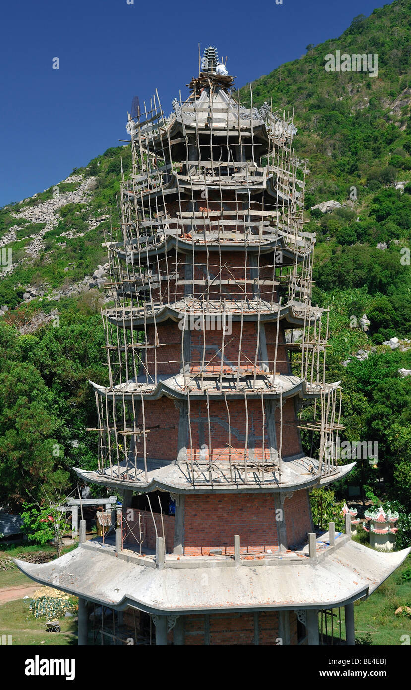 Framing with a simple scaffolding, temple tower on the mountain of the ...