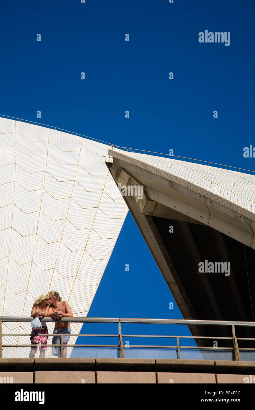 A couple enjoy a moment under the arches of the Sydney Opera House ...