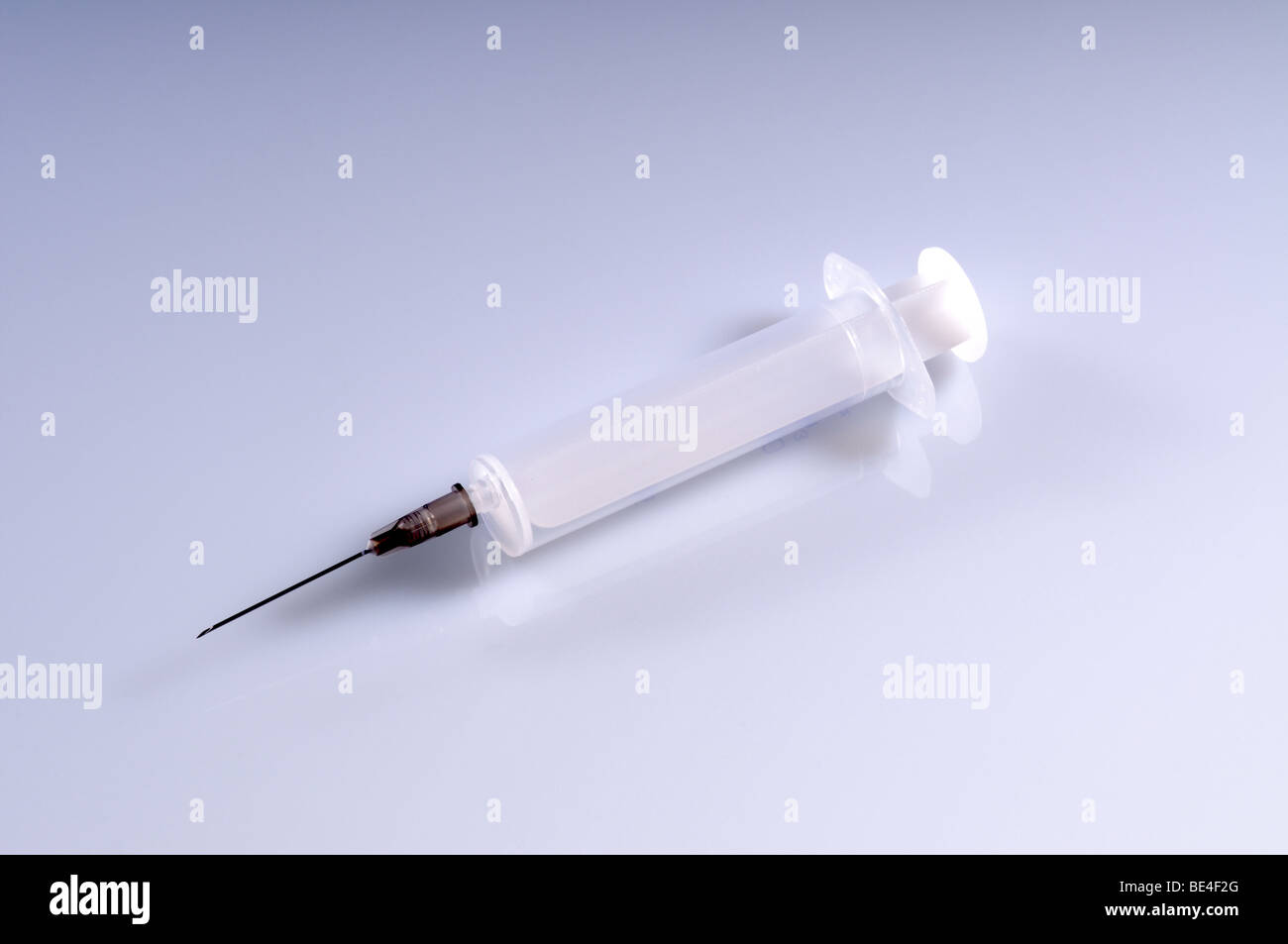 Plastic syringe and a needle on a white background Stock Photo - Alamy