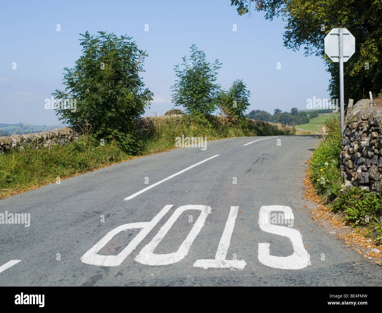A stop sign painted on the road at a junction in the Peak District ...