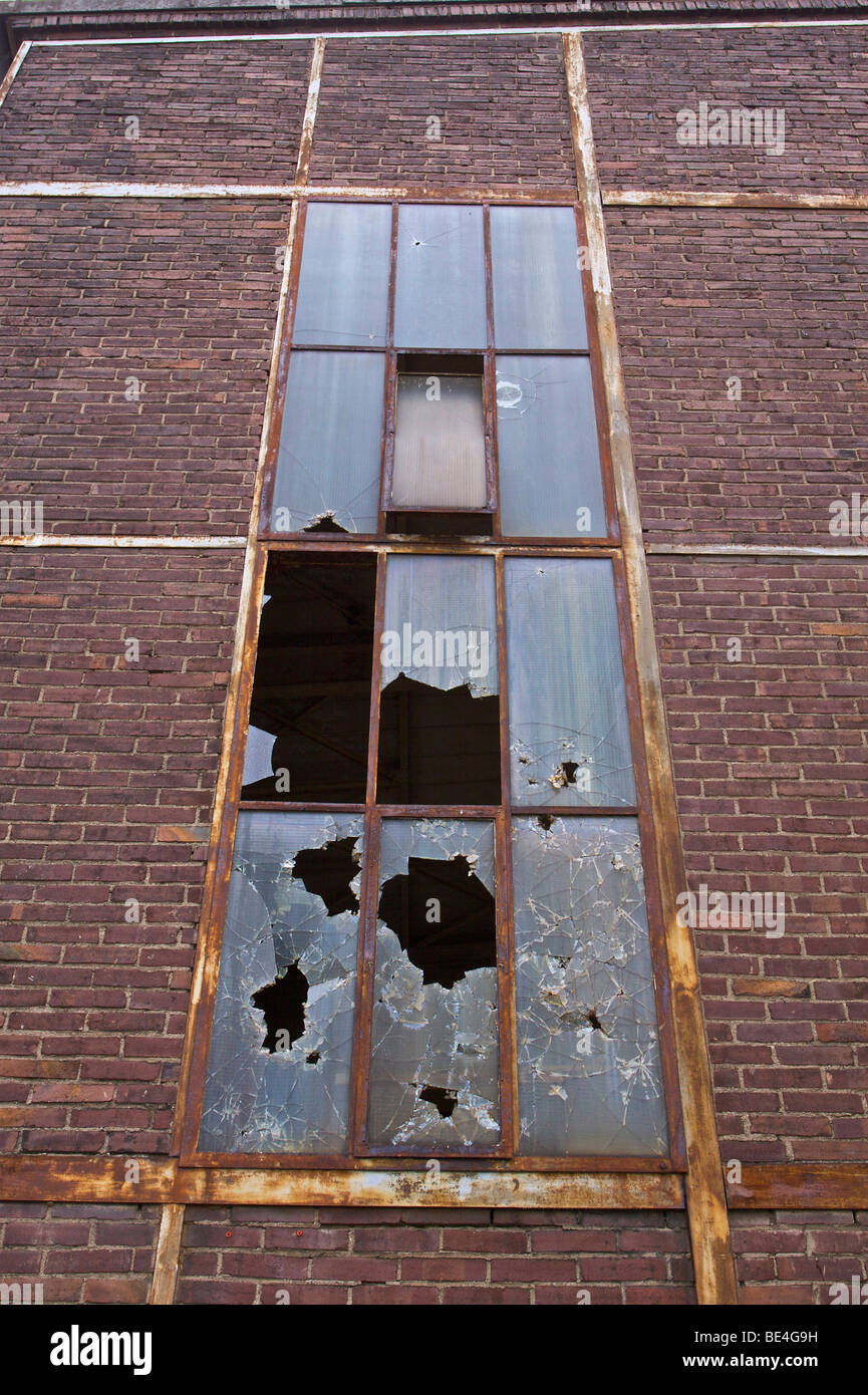 Broken windows in the facade, factory building on factory premises of ...