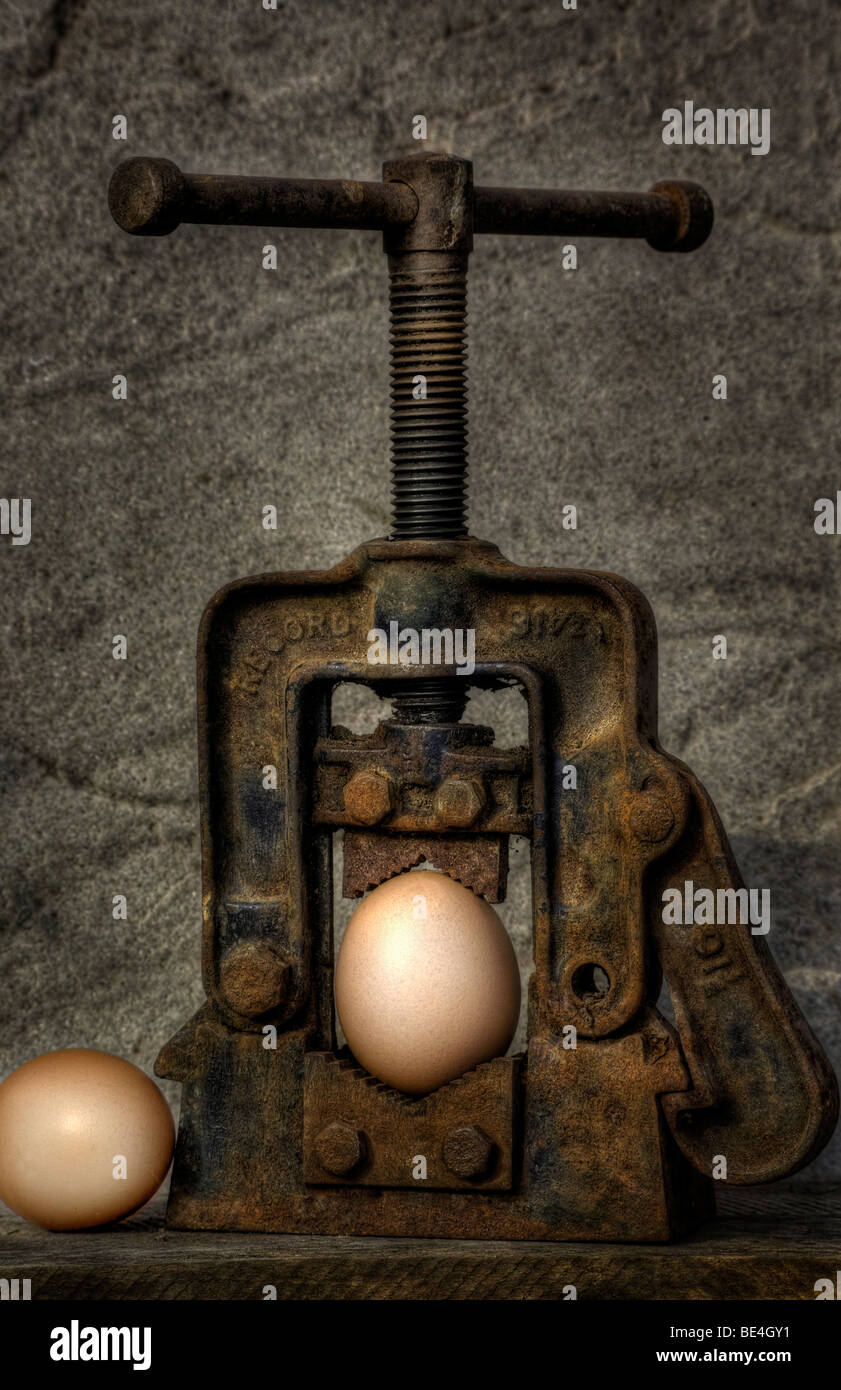 Rusty vice / clamp with egg. Depicting strength, vulnerability Stock ...