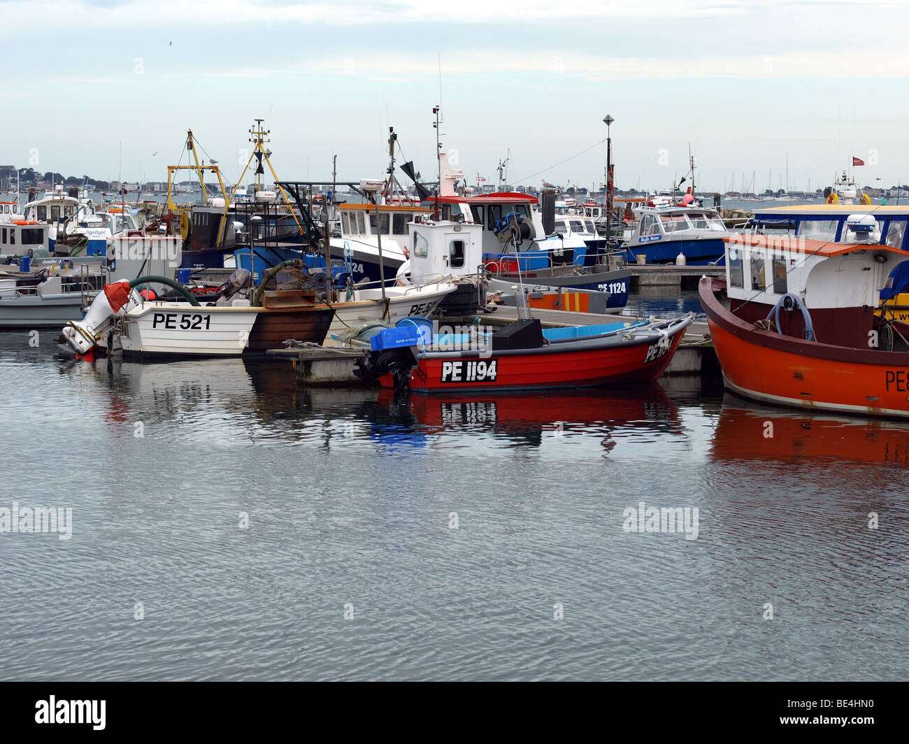 Reflections of fishing boats dorset hi-res stock photography and images ...