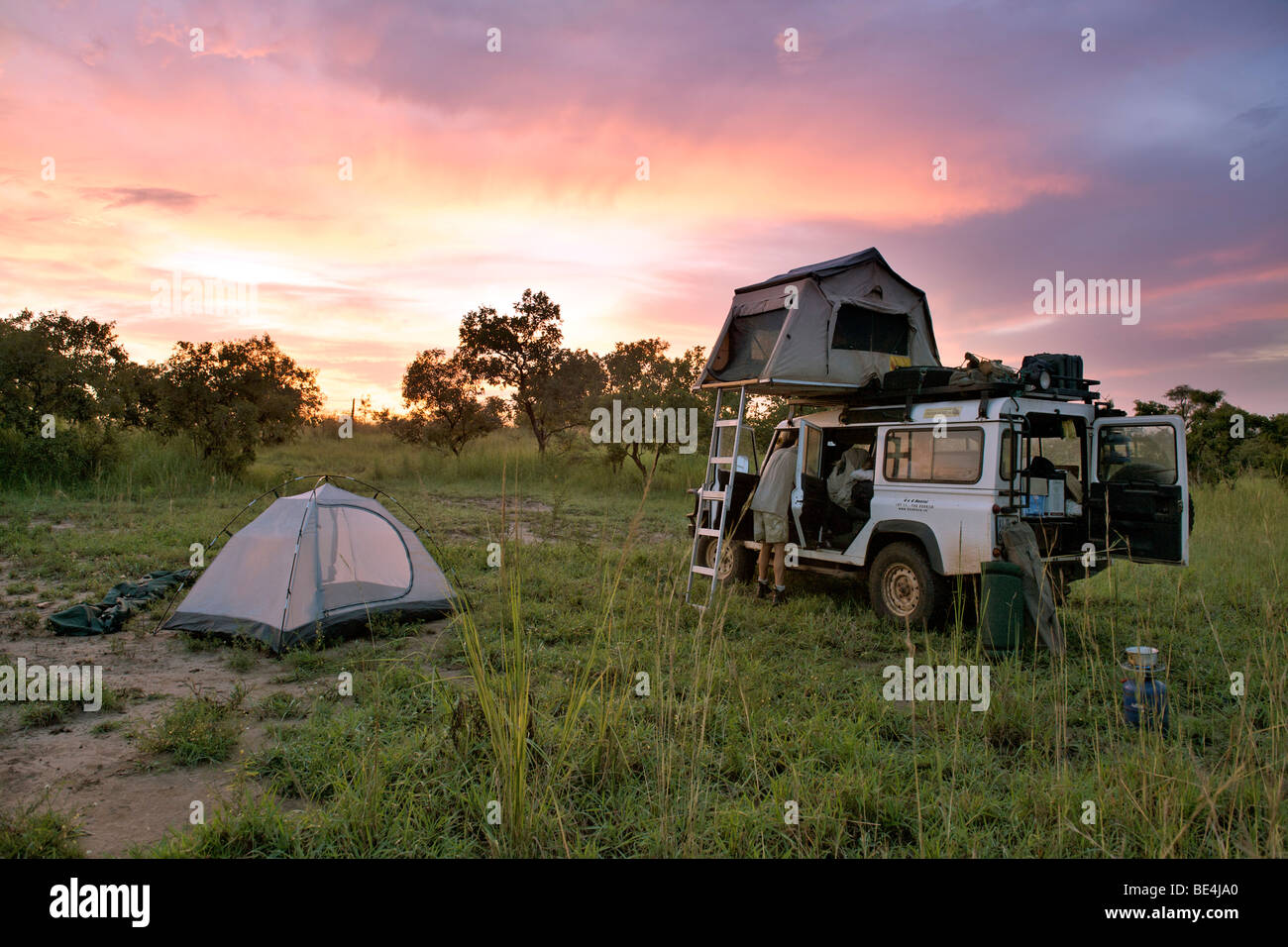 Dawn view of a Land Rover and tents in Murchison Falls National Park in ...