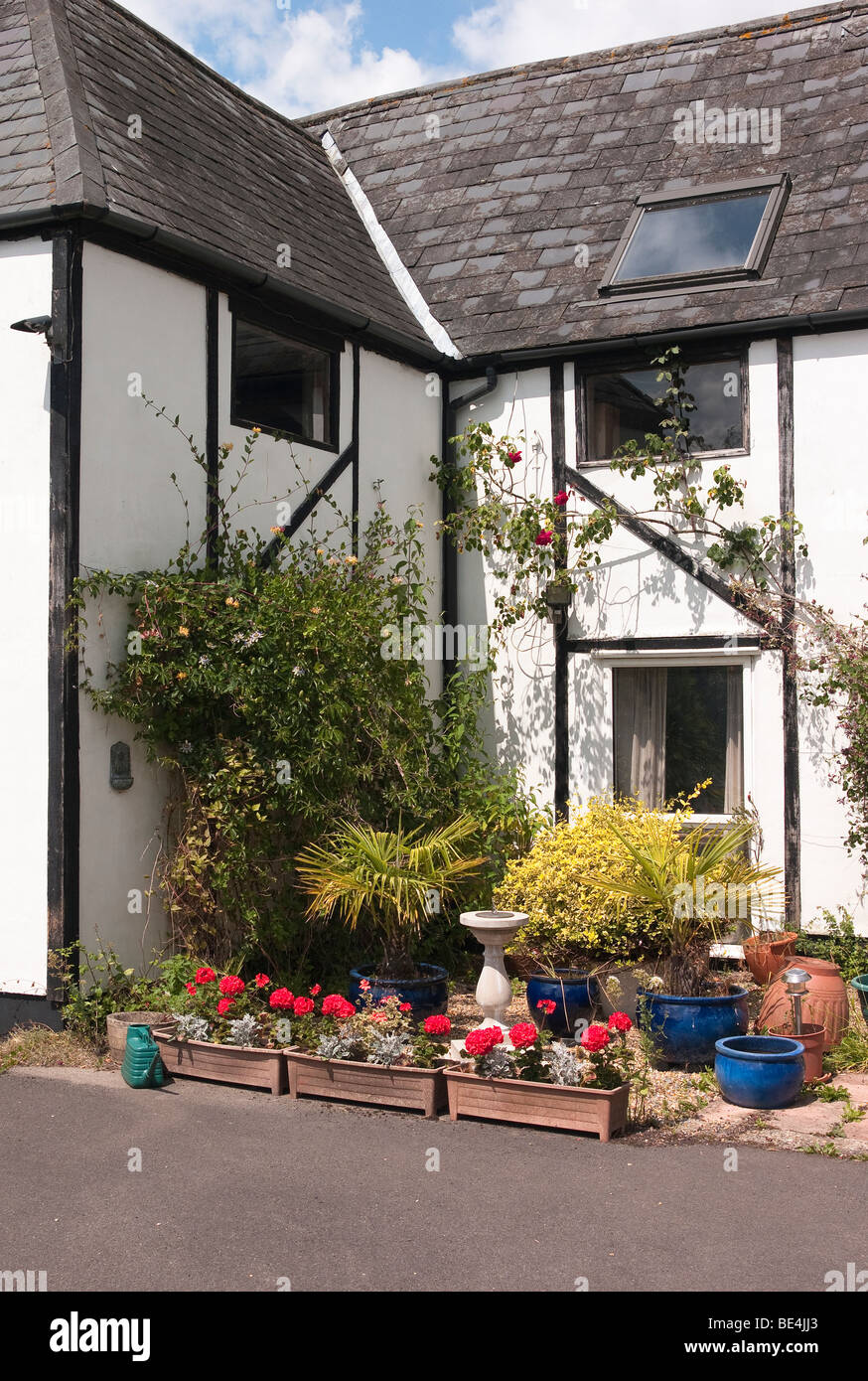 Part of a converted English barn with small garden Stock Photo - Alamy