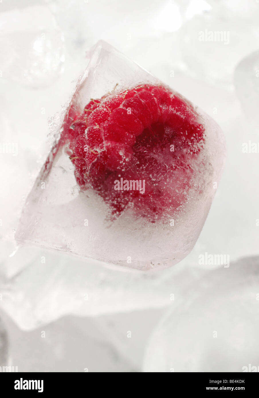 Raspberry frozen in ice cube Stock Photo - Alamy