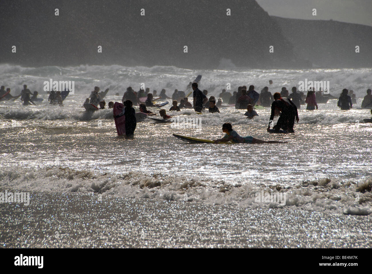 Surfers and body boarders in surf on Perranporth beach Cornwall UK ...