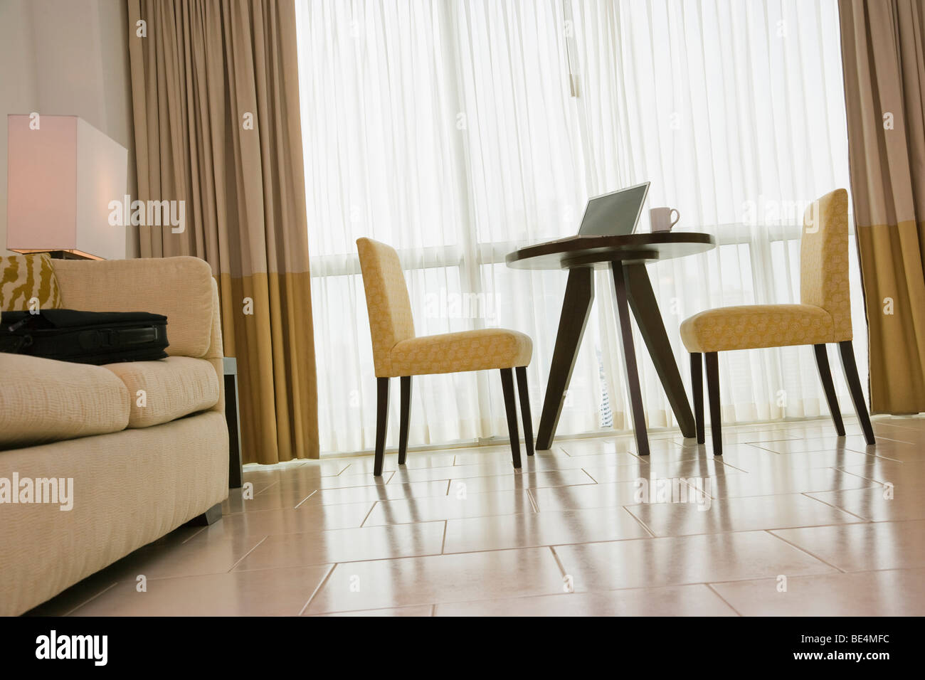 Laptop on table in hotel room Stock Photo - Alamy