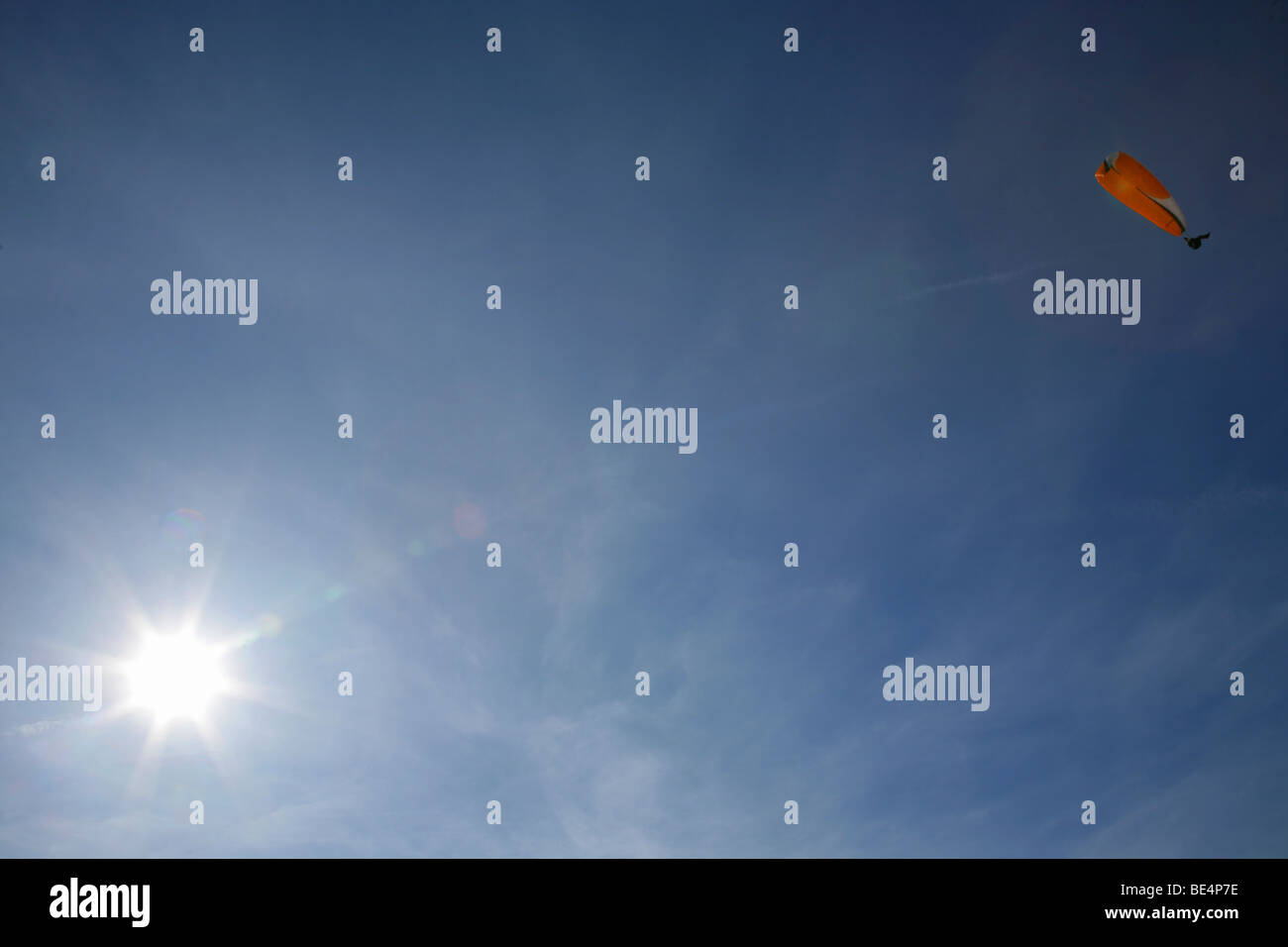 Parasailer with orange canopy Stock Photo - Alamy