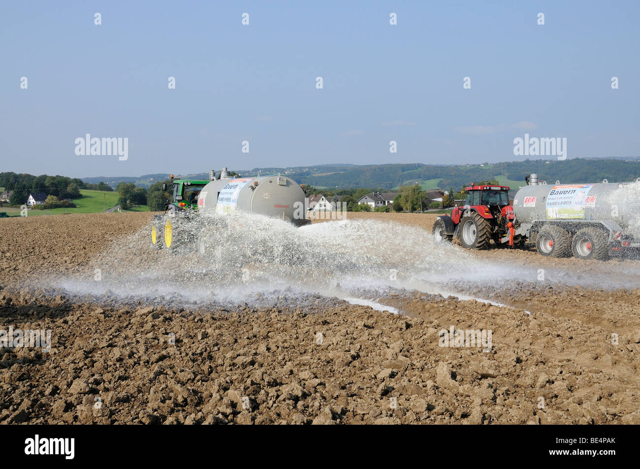 Dairy farmers dumping their milk in protest on a field, Overath ...