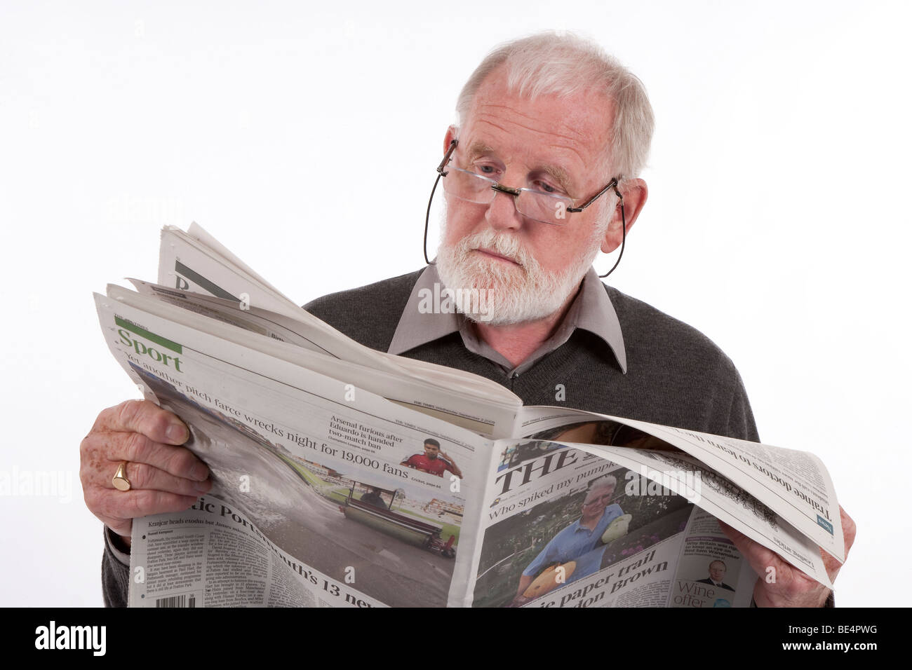 Older retired man reading daily newspaper Stock Photo - Alamy