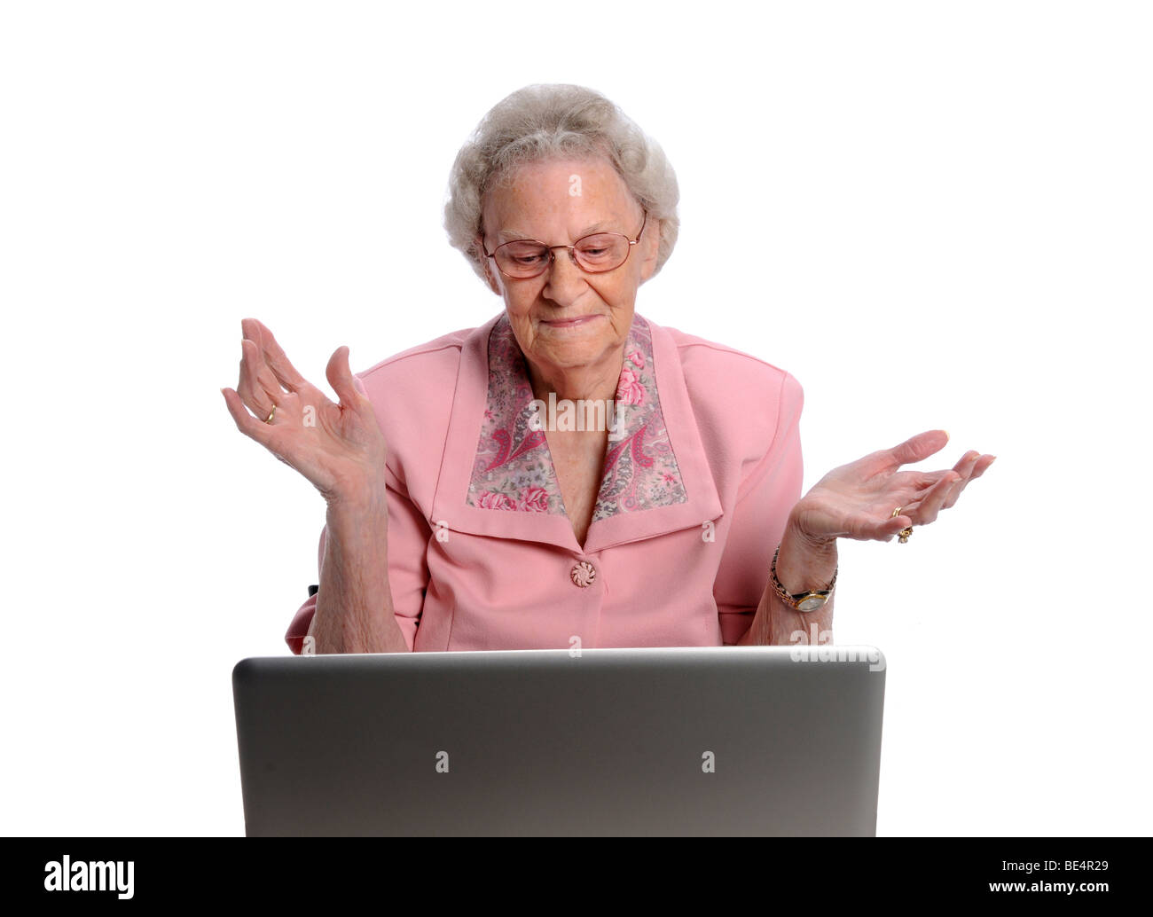 Senior woman throwing hands in front of laptop computer isolated over ...