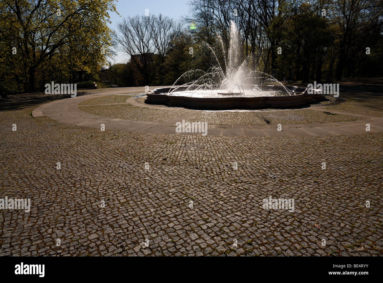 Fountain with running water and pavement Stock Photo - Alamy