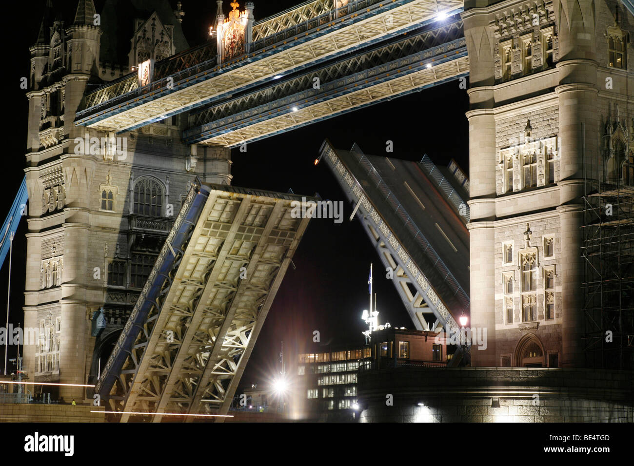 Lift bridge opened at night to let shipping traffic pass, Tower Bridge ...