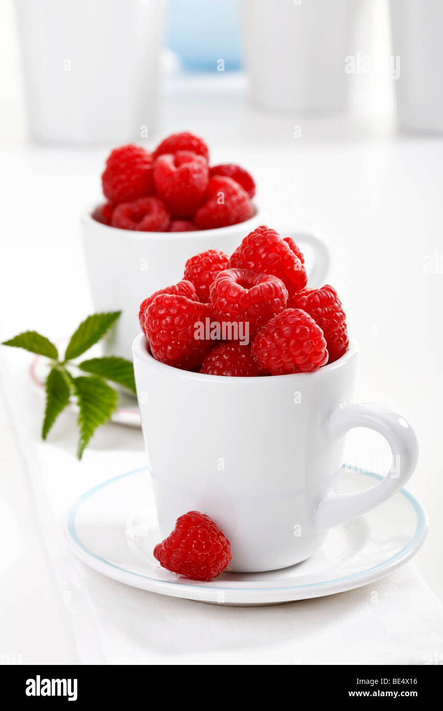 Raspberries in espresso cups with raspberry leaves Stock Photo - Alamy