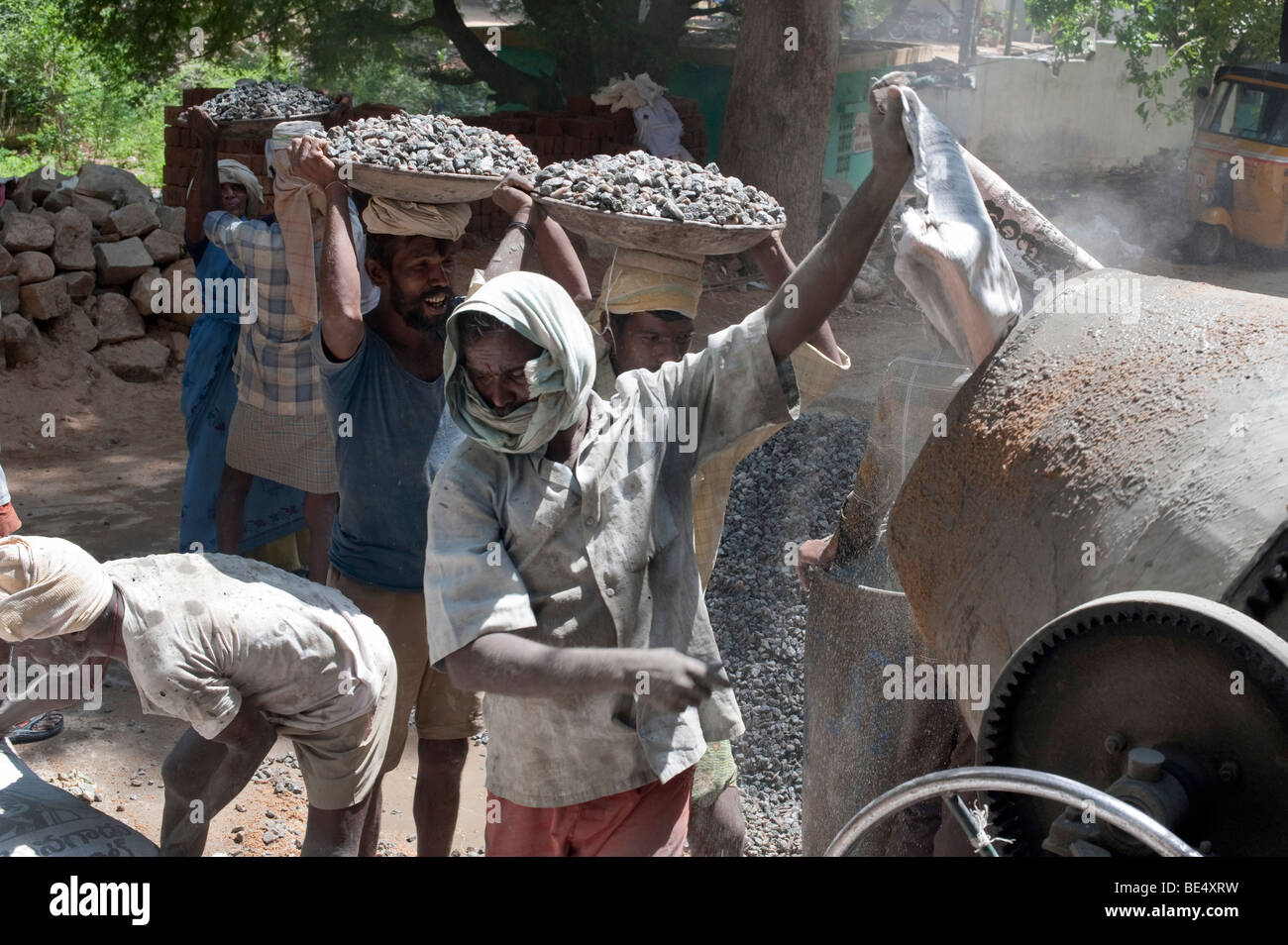 Indian construction workers mixing rock sand and cement to make Stock ...