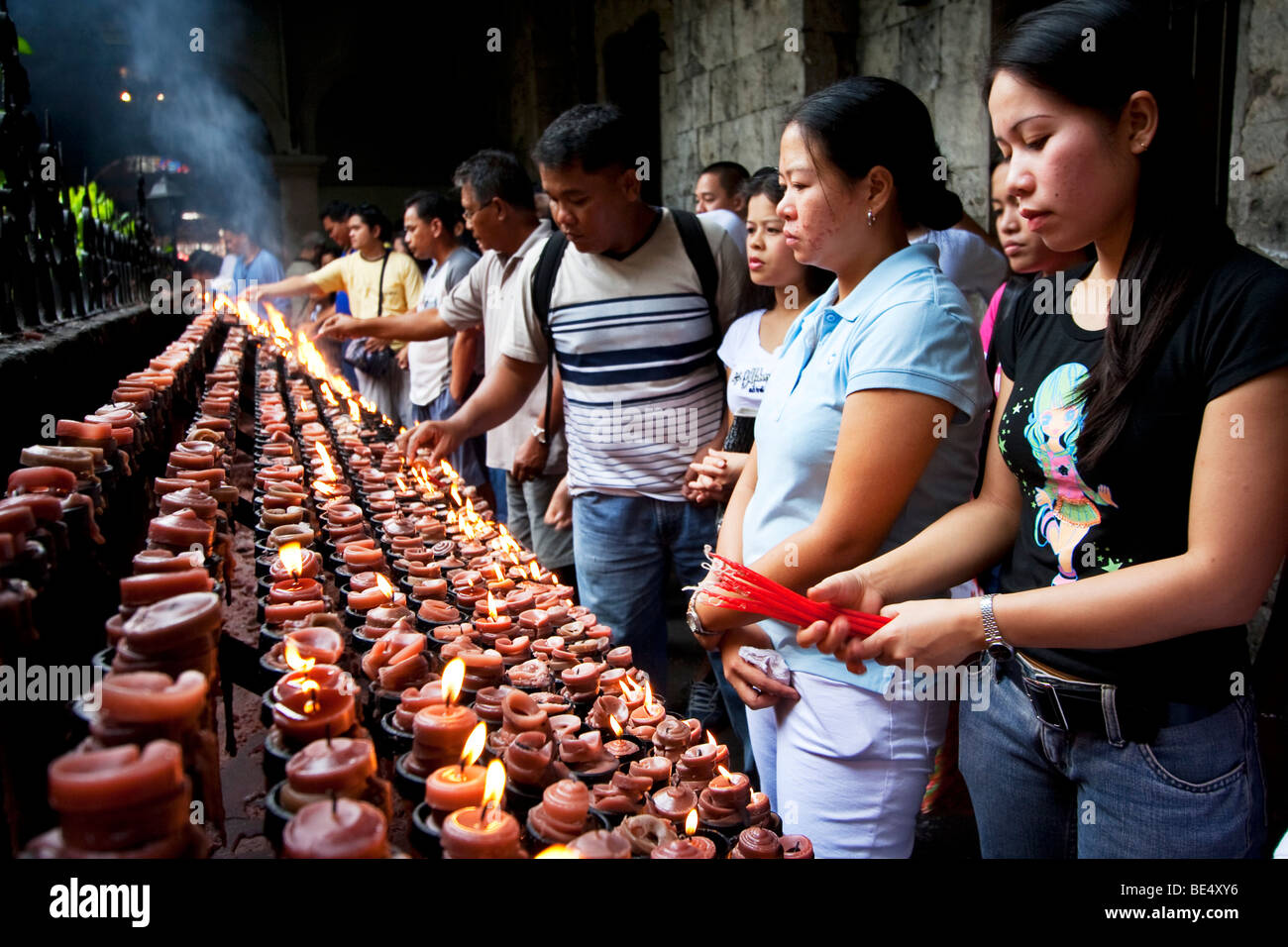Religious devotees inside the Basilica del Sto. Nino praying Stock ...