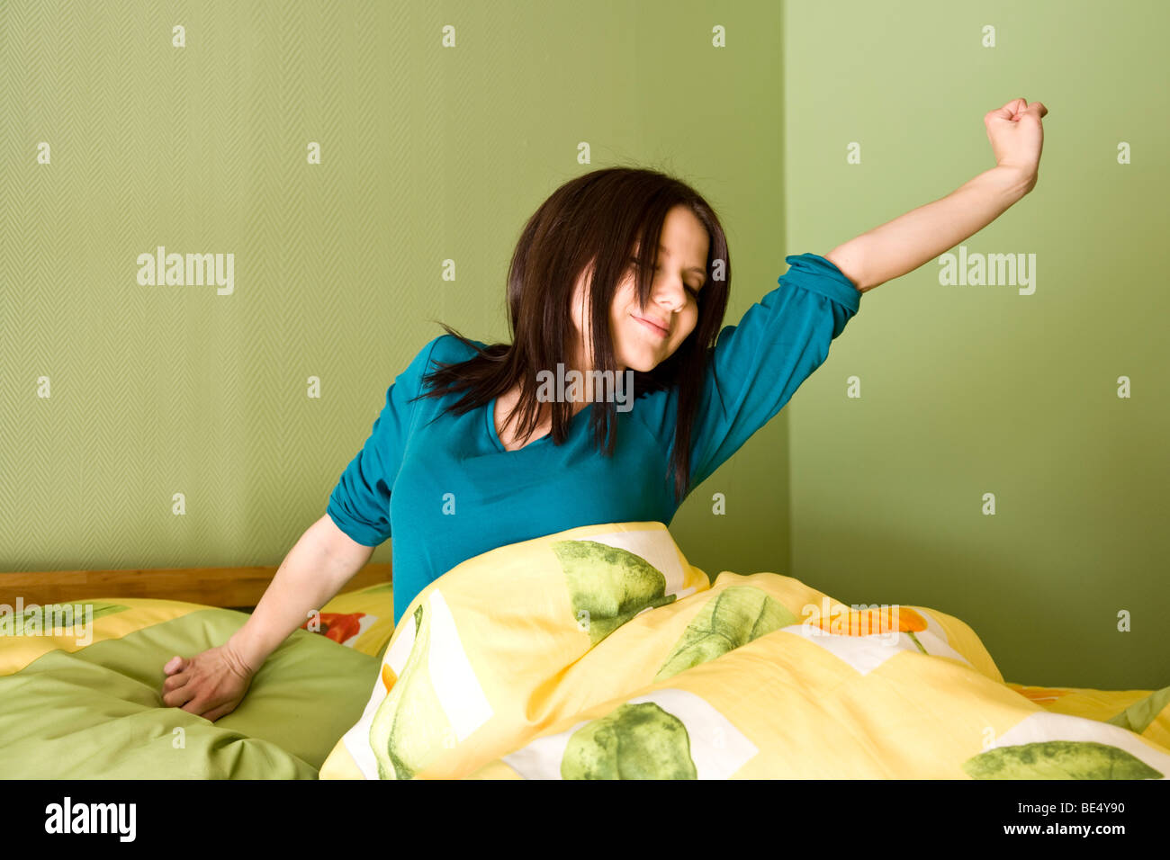 Woman getting out of bed stretching hi-res stock photography and images ...