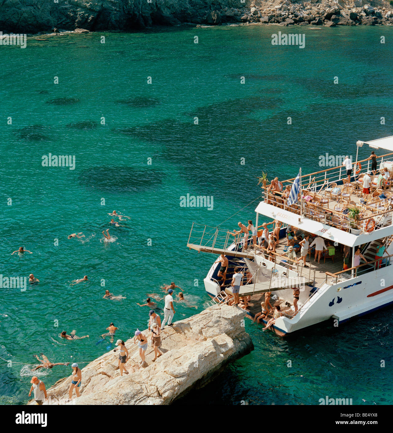 People climbing off a boat on to a rock hi-res stock photography and ...