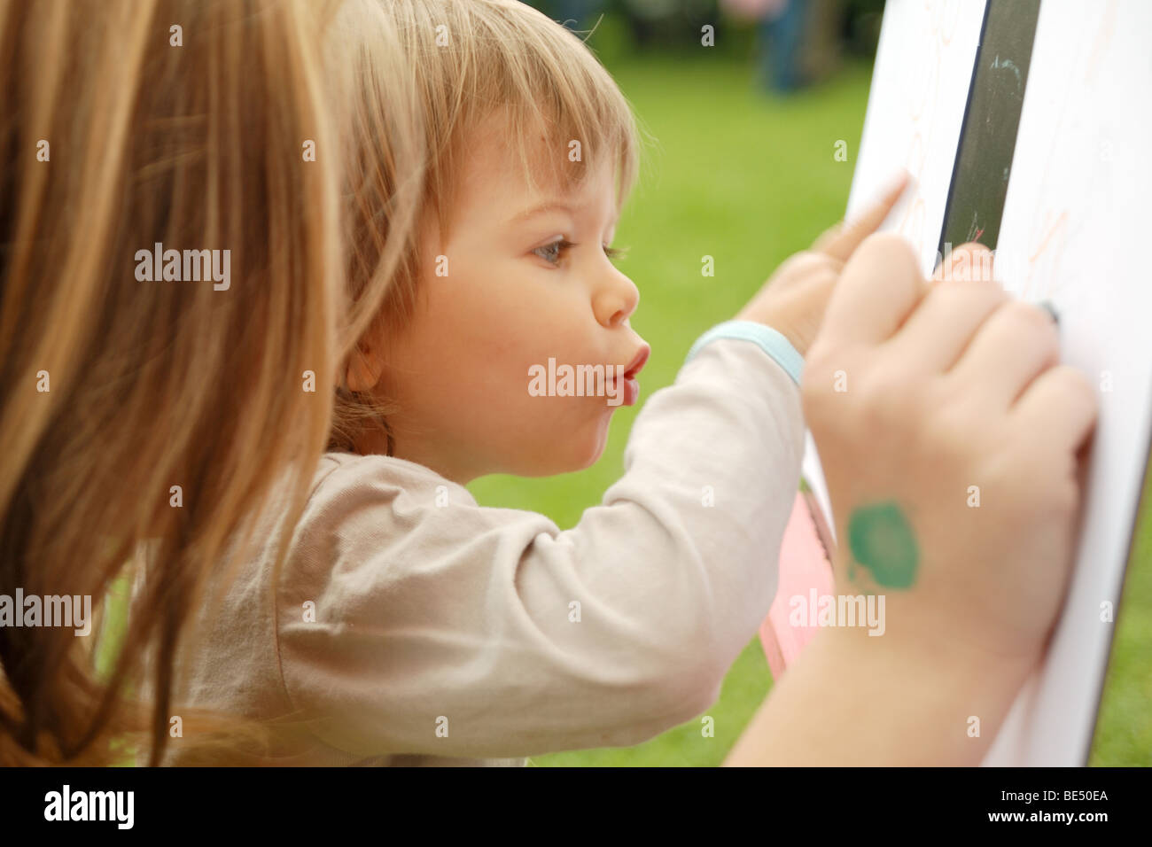 Child learning to draw with crayons Stock Photo - Alamy