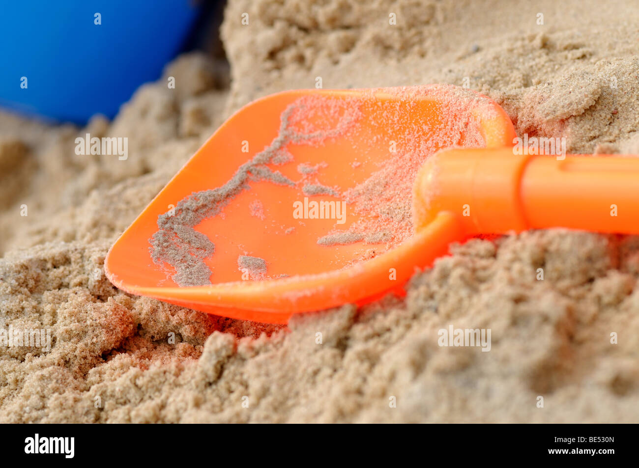 Closeup of children's spade on a beach sand Stock Photo - Alamy