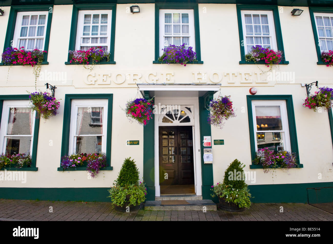 Exterior of the GEORGE HOTEL with hanging flower baskets in town of ...