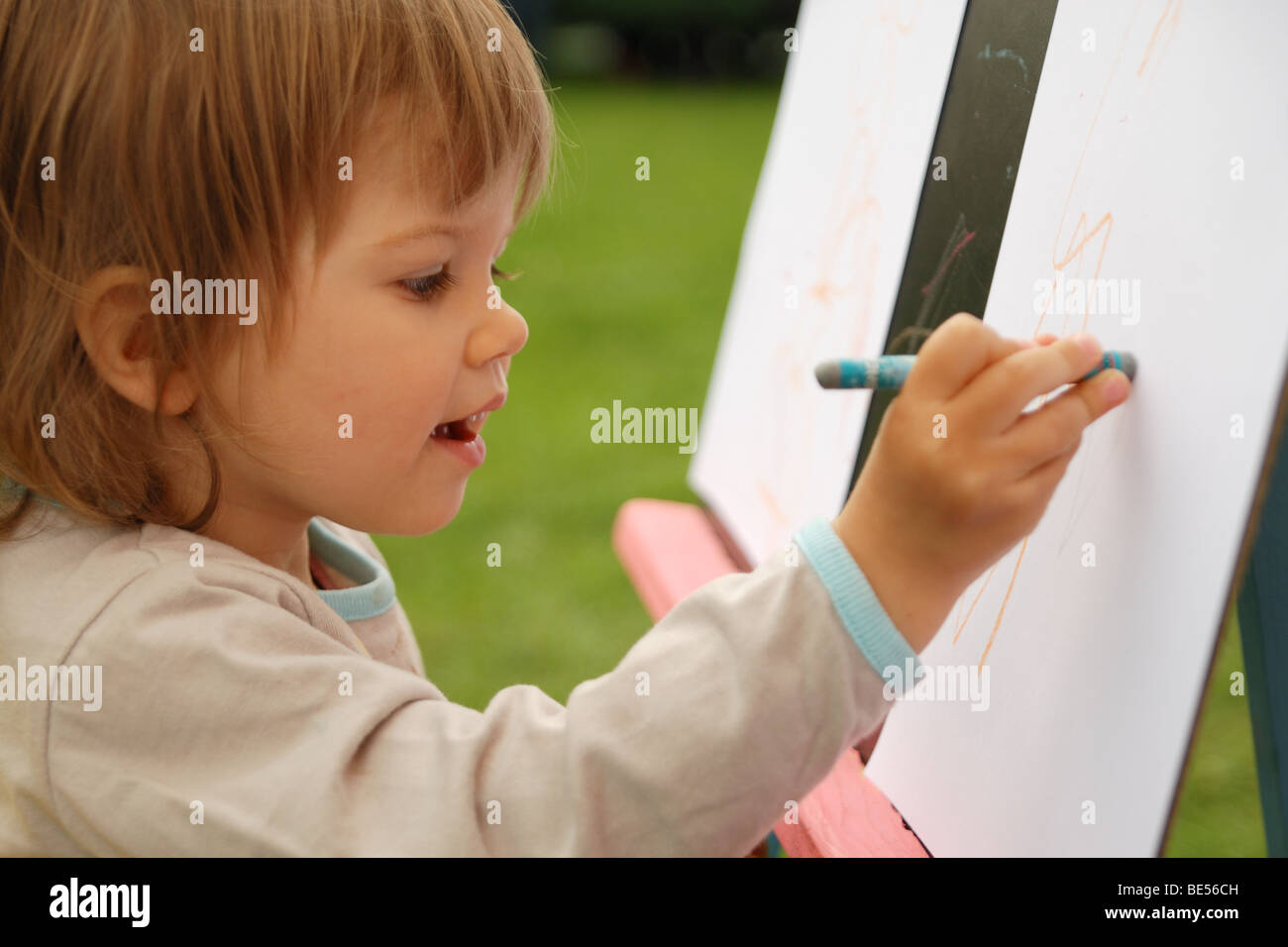 Child learning to draw with crayons Stock Photo - Alamy