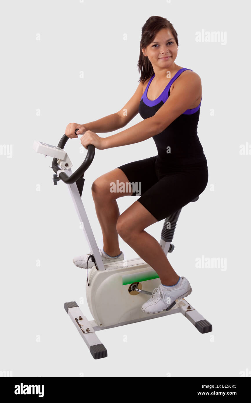 Girl on exercise bike Stock Photo - Alamy