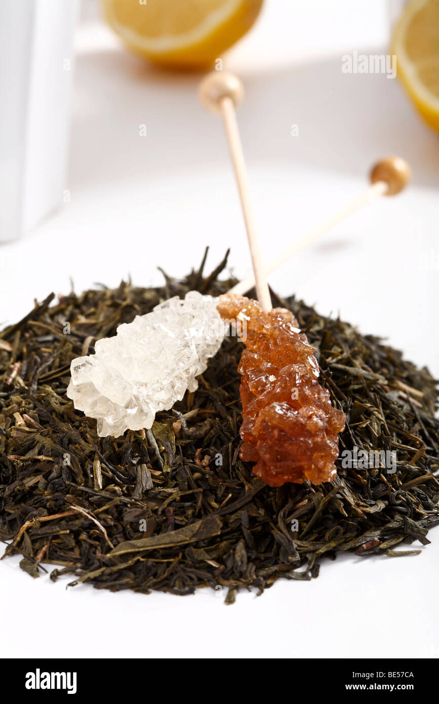 Two sugar sticks on a bed of green tea Stock Photo - Alamy
