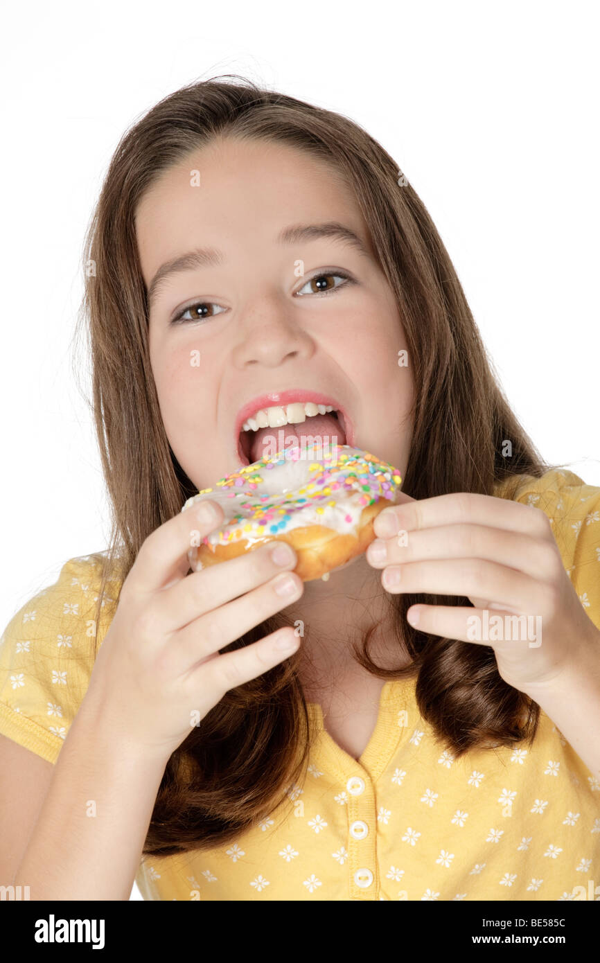 Cute Caucasian girl eating a donut on a white background Stock Photo ...
