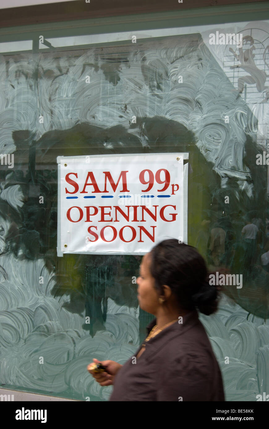 sign on whitewashed shop window announcing the opening of a branch of ...