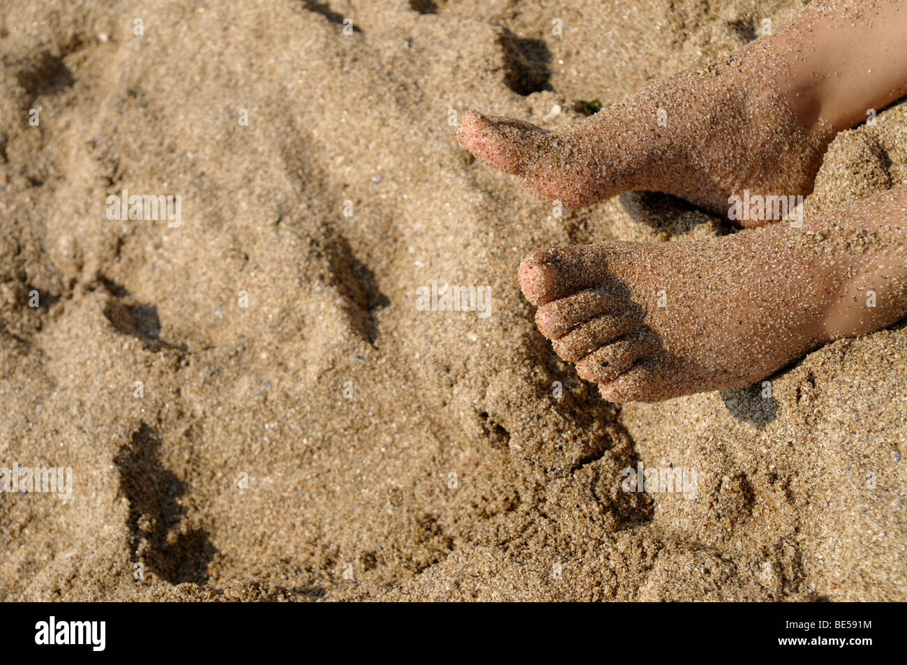 Feet in sand on the beach Stock Photo - Alamy