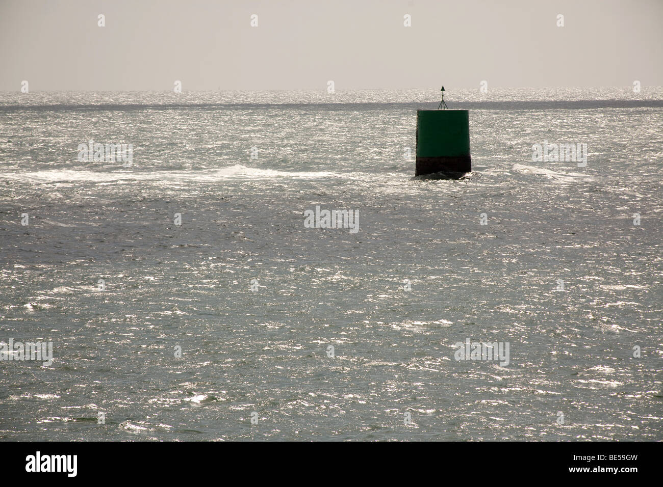 concrete beacon in atlantic ocean wth silver reflection and glint on ...