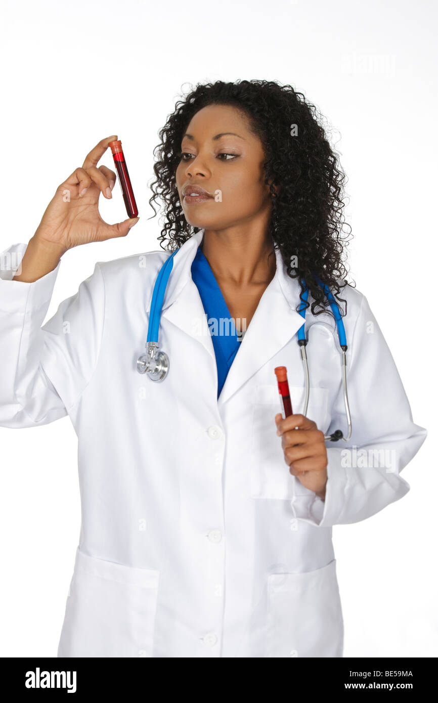 Beautiful African American laboratory technician examining a tube of ...