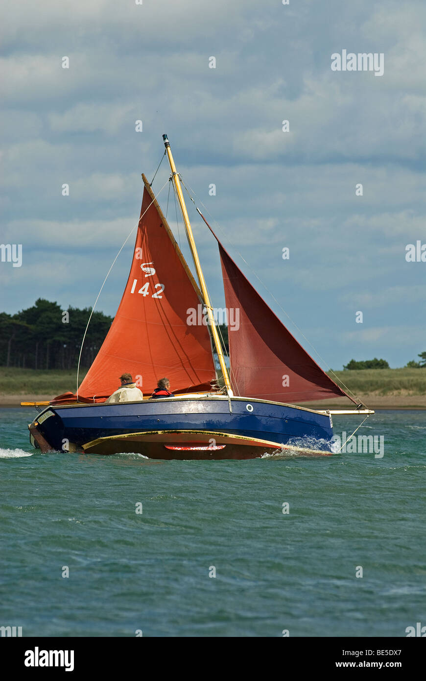 A Cornish Shrimper reefed down beating back into Wells Harbour Stock ...