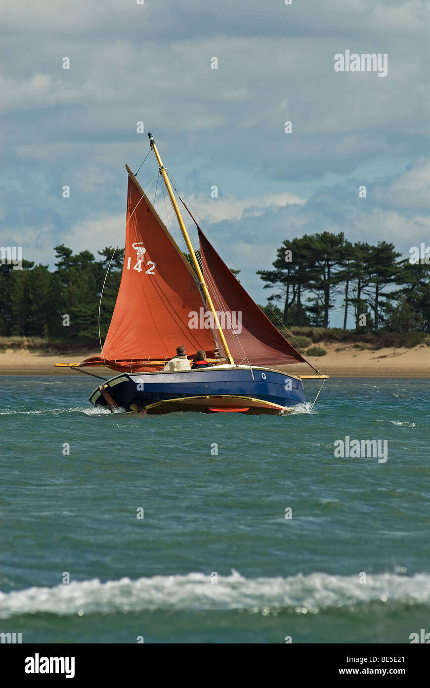 A Cornish Shrimper reefed down beating back into Wells Harbour Stock ...