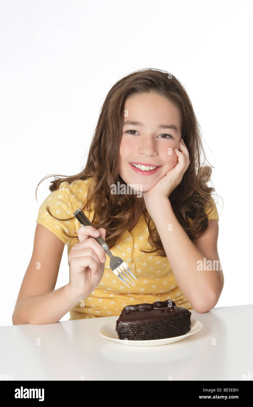 Cute Caucasian child eating a slice of chocolate cake Stock Photo - Alamy