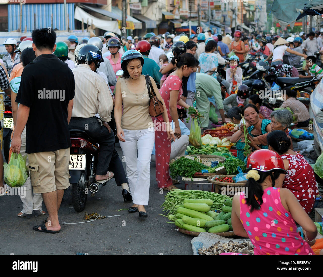 Many people crowd on the road at a street market, Vinh Longh, Mekong ...
