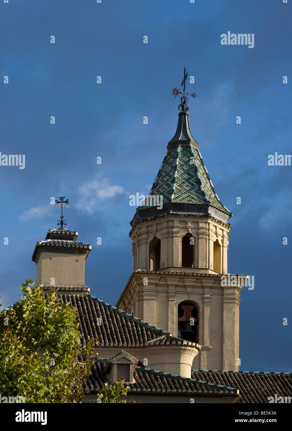 Tiled roof and bell tower of typical Spanish church in Andalucia in ...