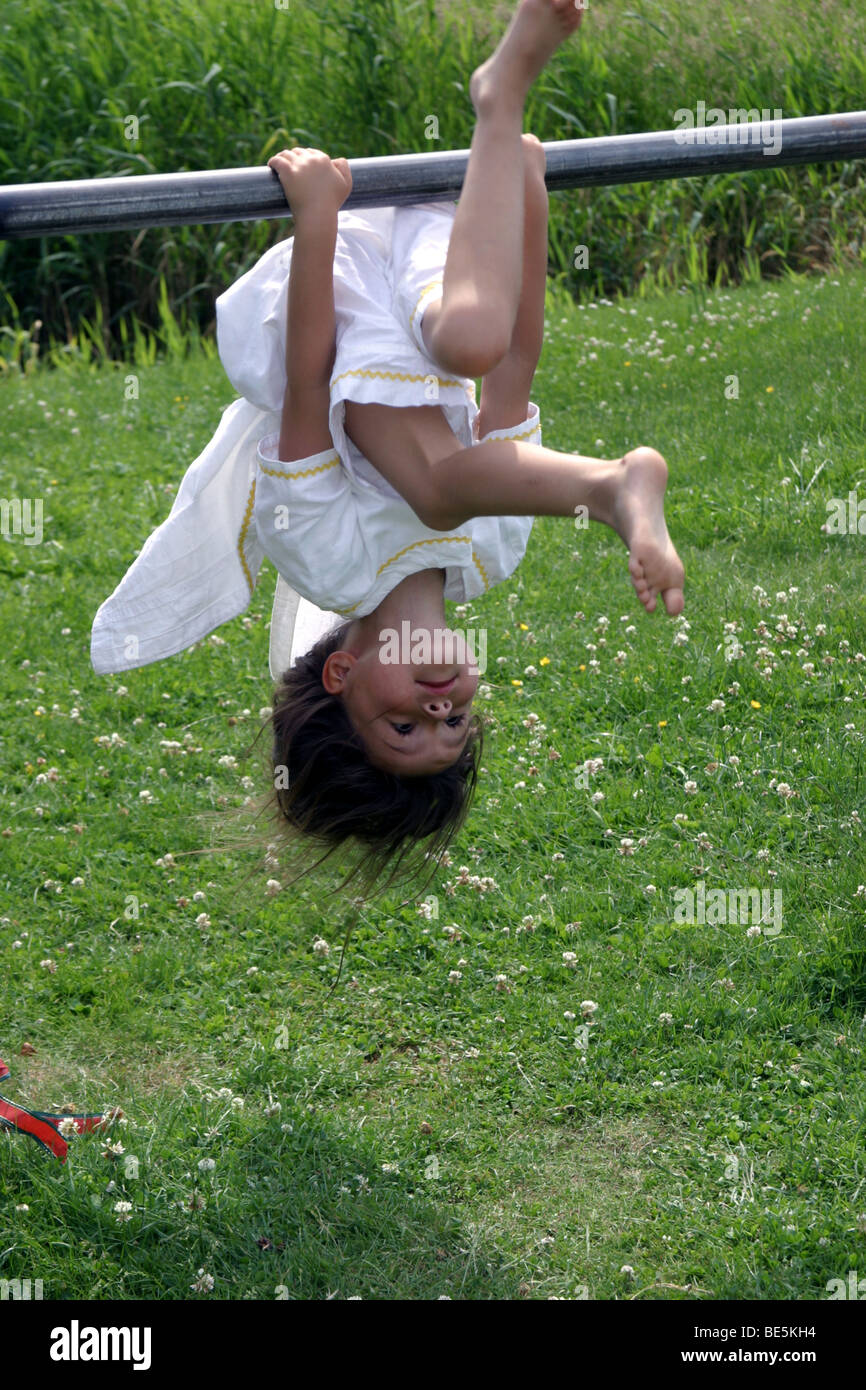 Child hanging upside down on climbing hi-res stock photography and images - Alamy