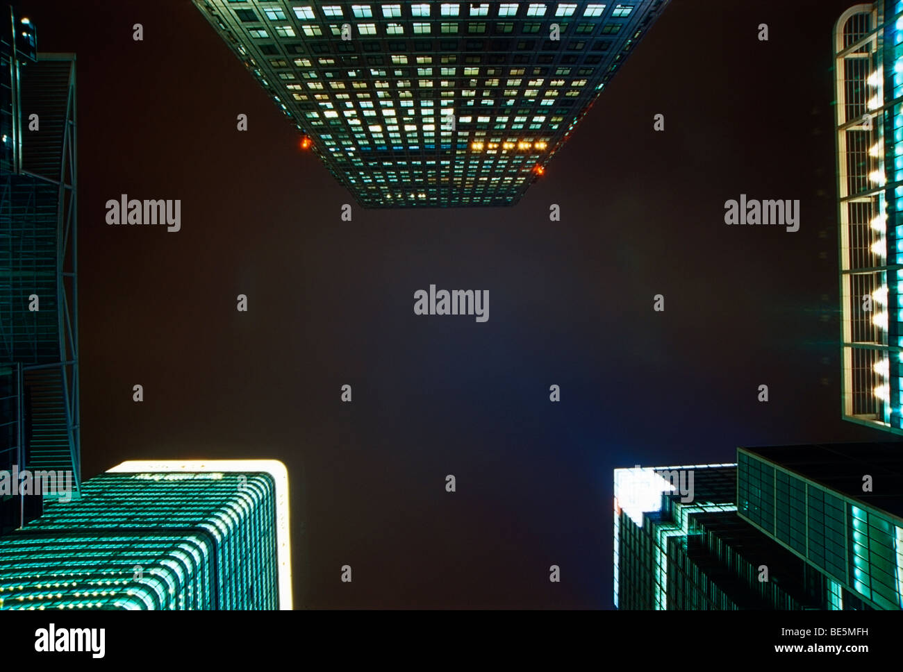 Looking up one canada square at the night sky between three skyscrapers ...